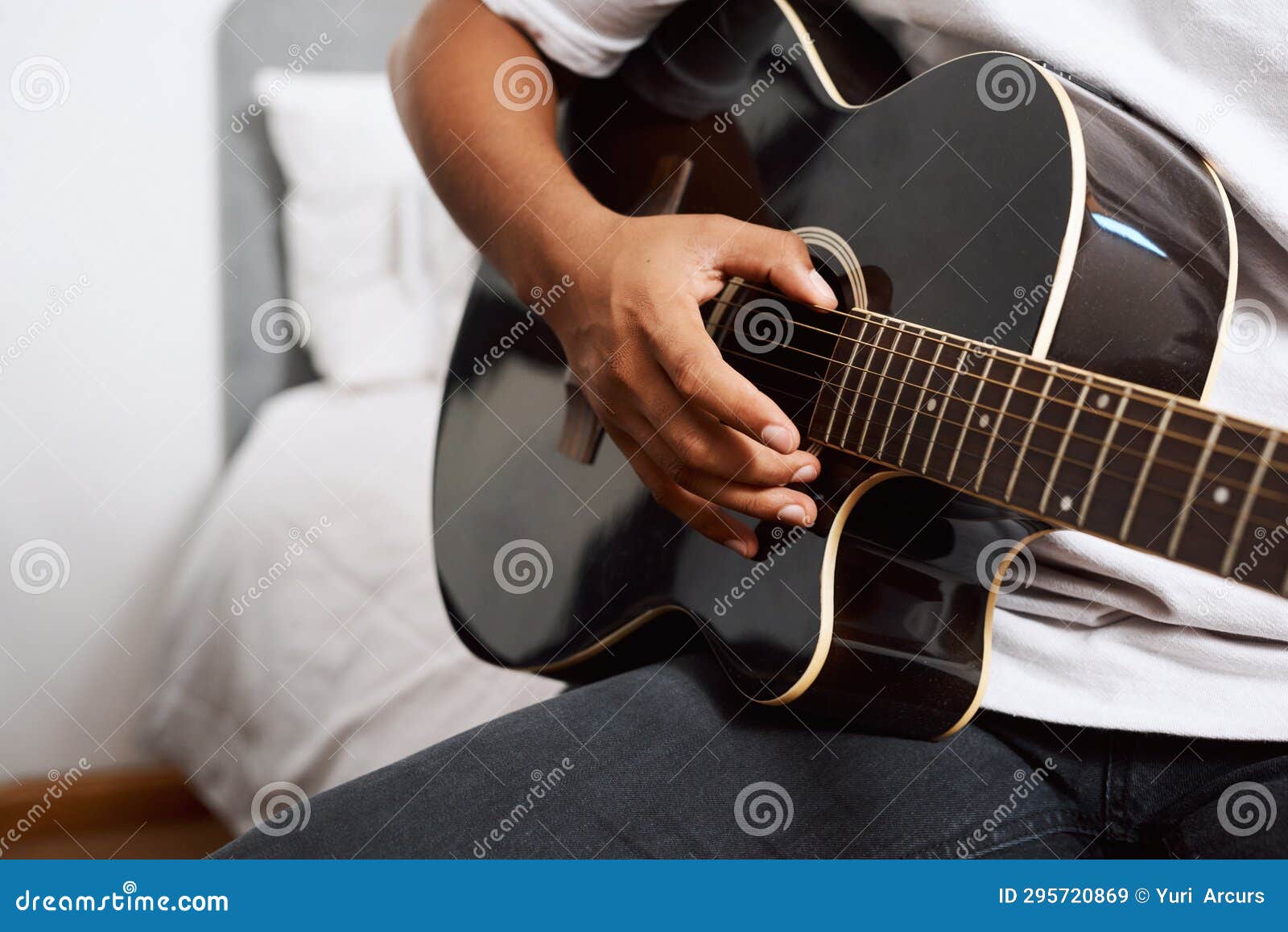 It Requires Patience, Perseverance and Dedication. a Young Man Playing the Guitar while Sitting ...