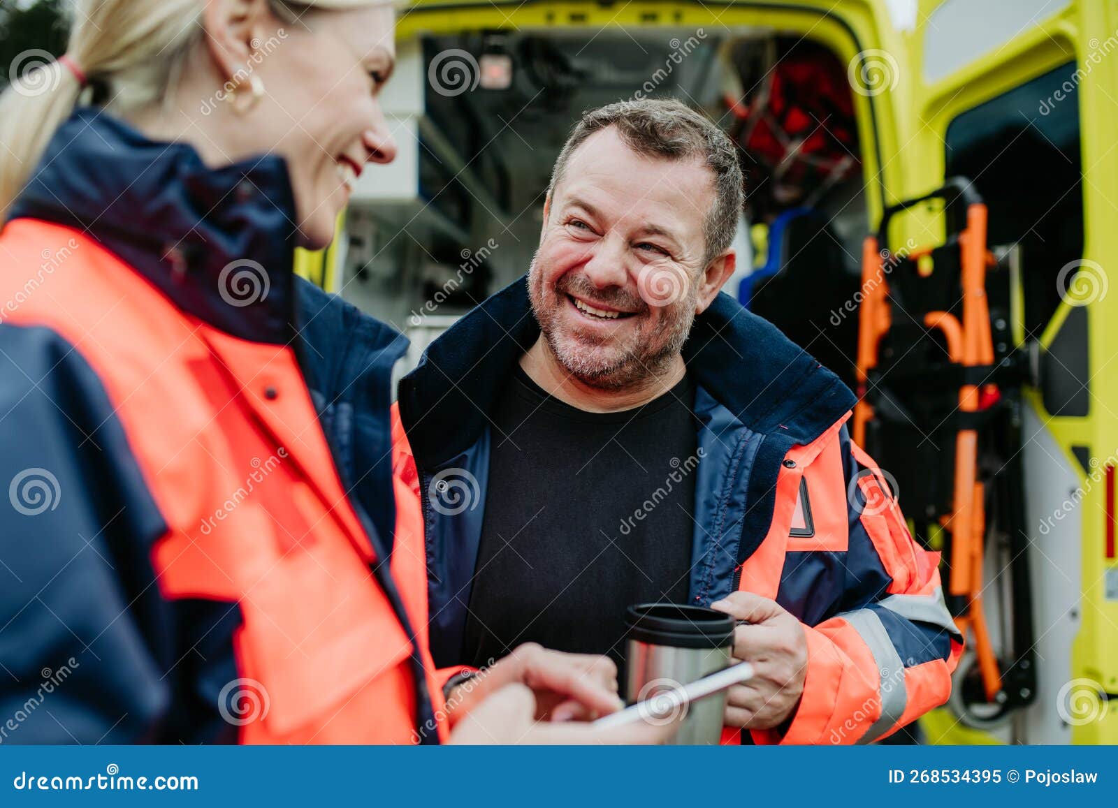 Rescuers Having Break in Front of Ambulance Car, Talking and Drinking ...