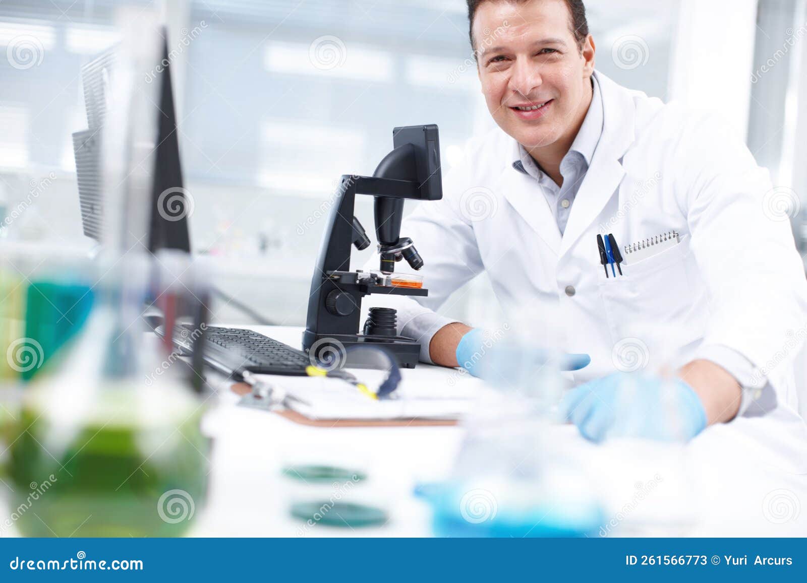 Research Saves Lives. a Researcher Smiling while Sitting at a Table in ...