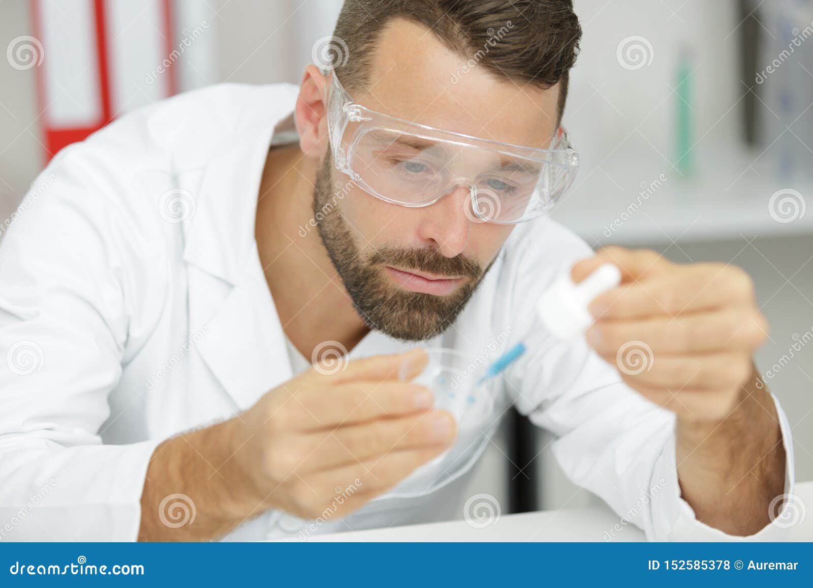 Research Worker Doing Experiments with Chemical Liquid at Laboratory ...