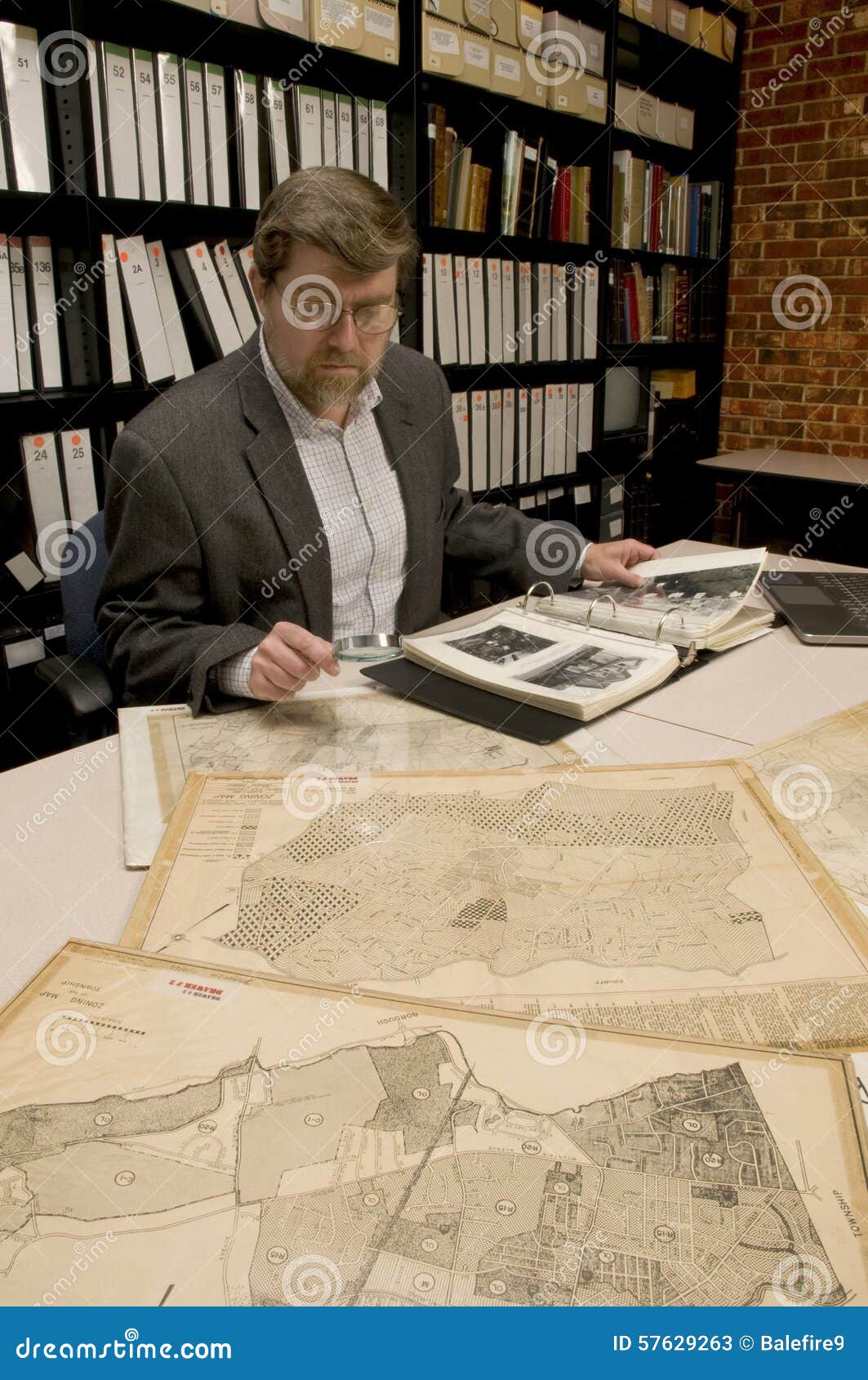 Researcher in Archive, Searching through Maps and Photographs. Stock ...