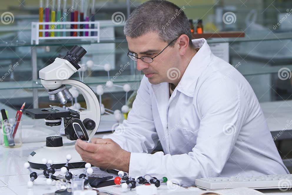Researcher Checking His Mobile Stock Photo - Image of keyboard, optics ...