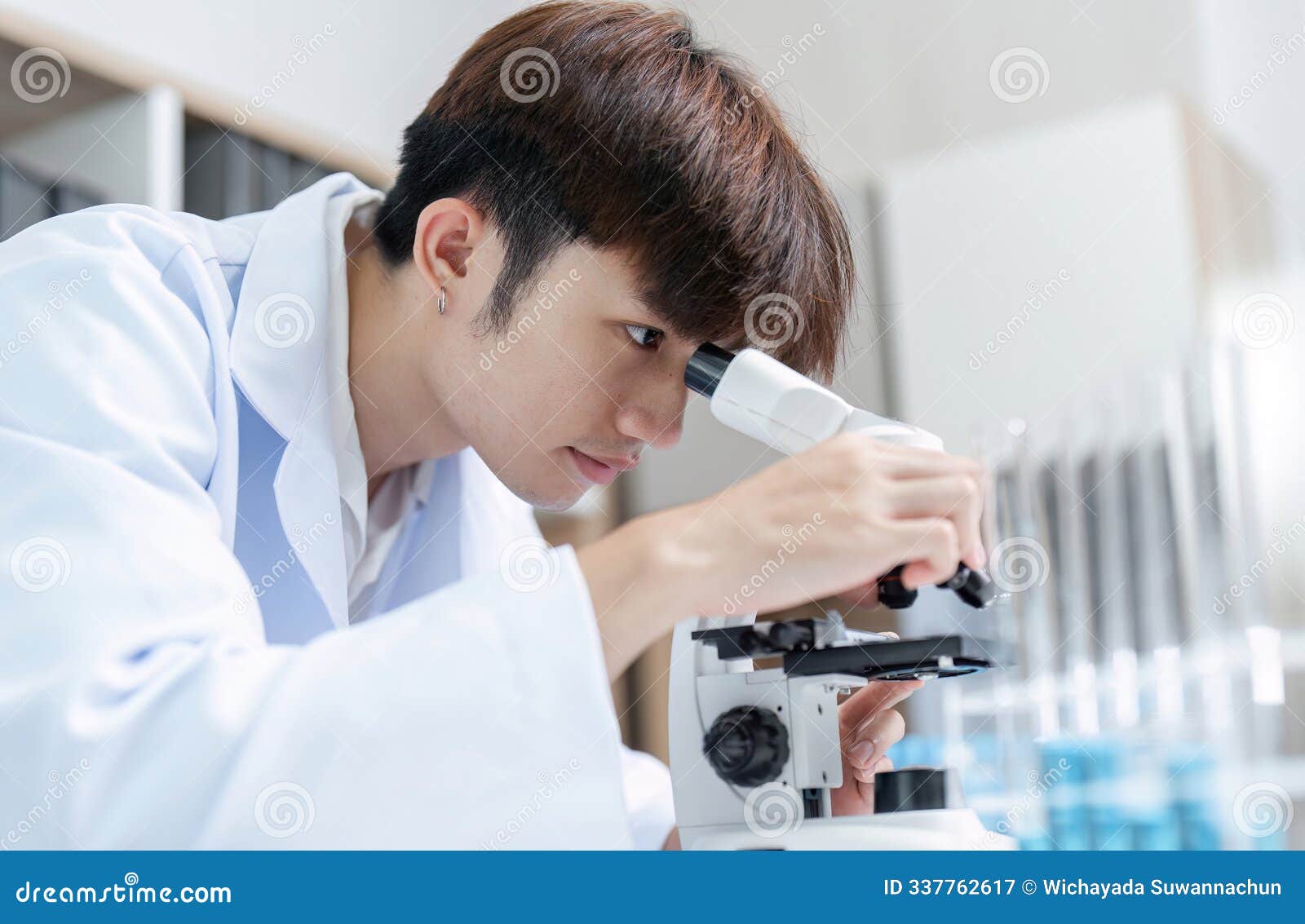 Researcher in Laboratory Examining Substance Under Microscope for ...