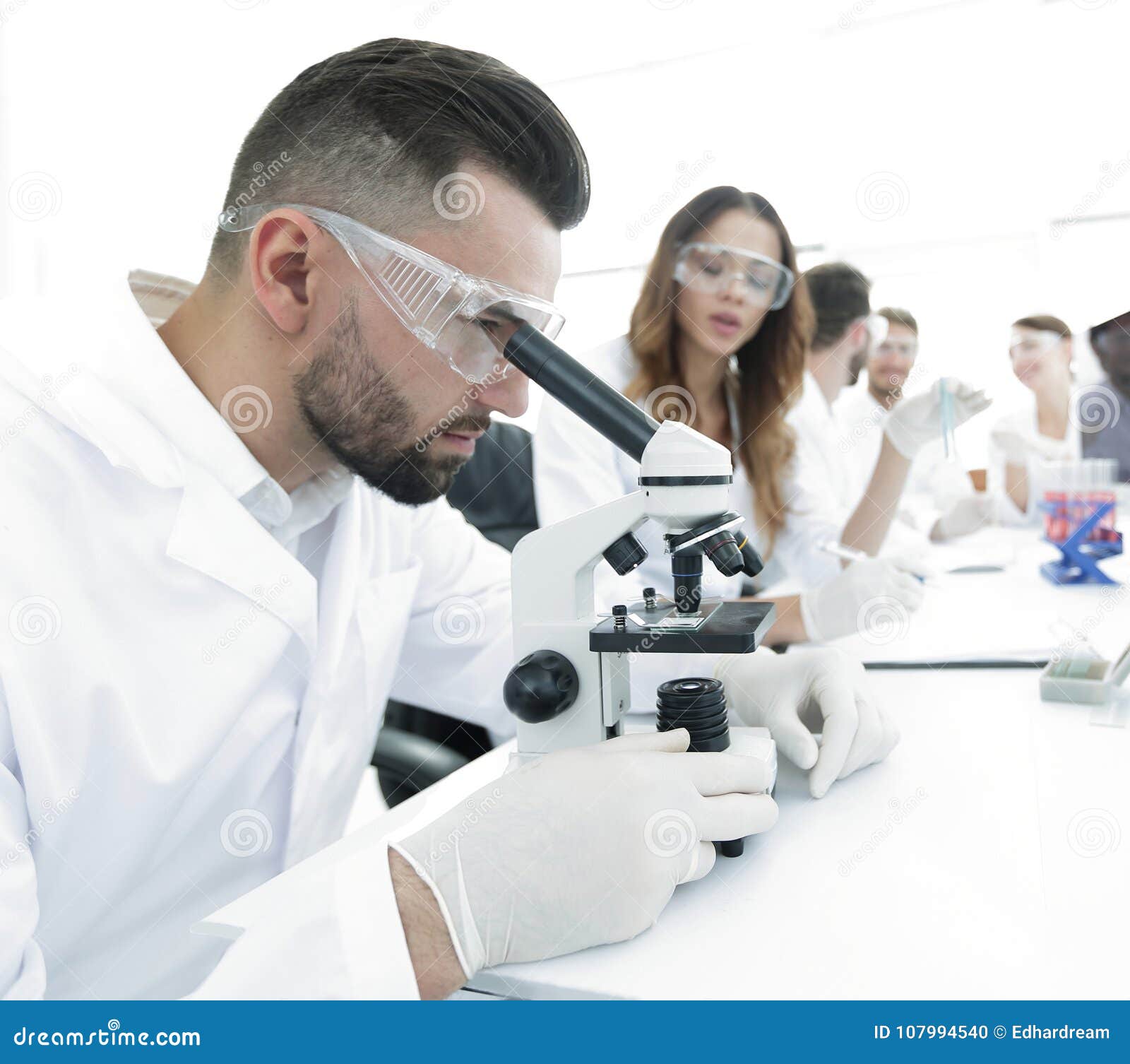 Researcher Looking into a Microscope in a Modern Laboratory Stock Photo ...