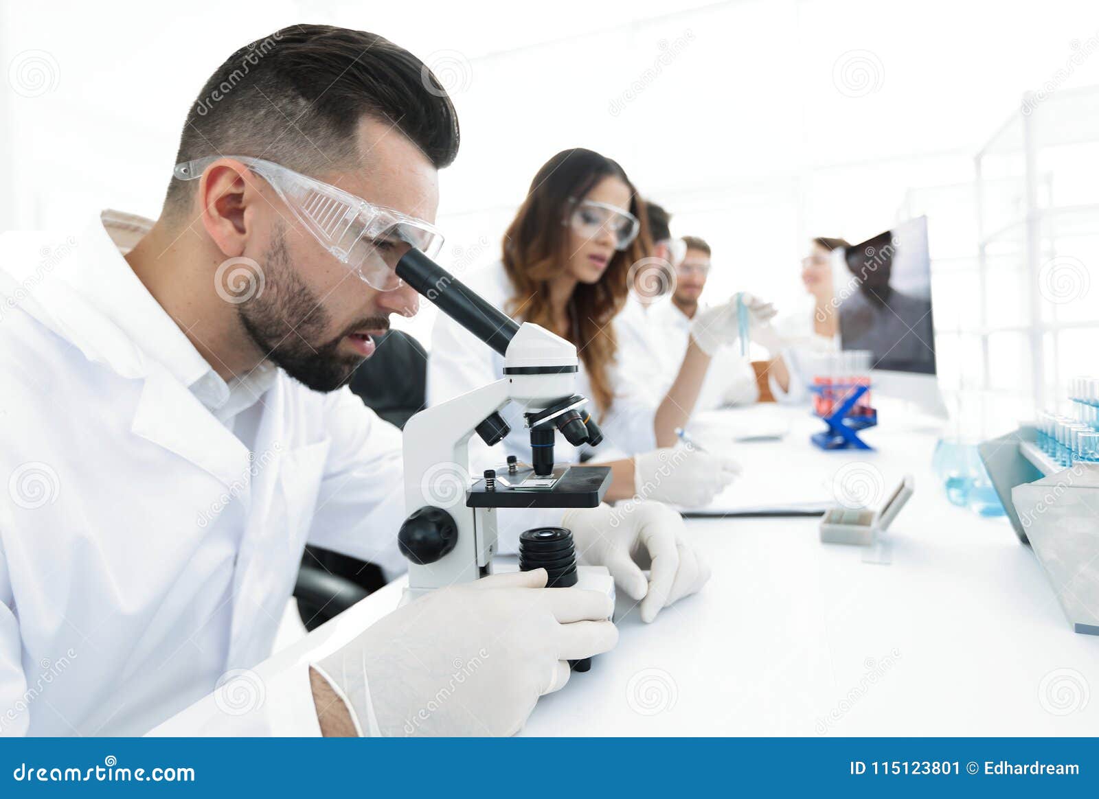 Researcher Looking into a Microscope in a Modern Laboratory Stock Image ...