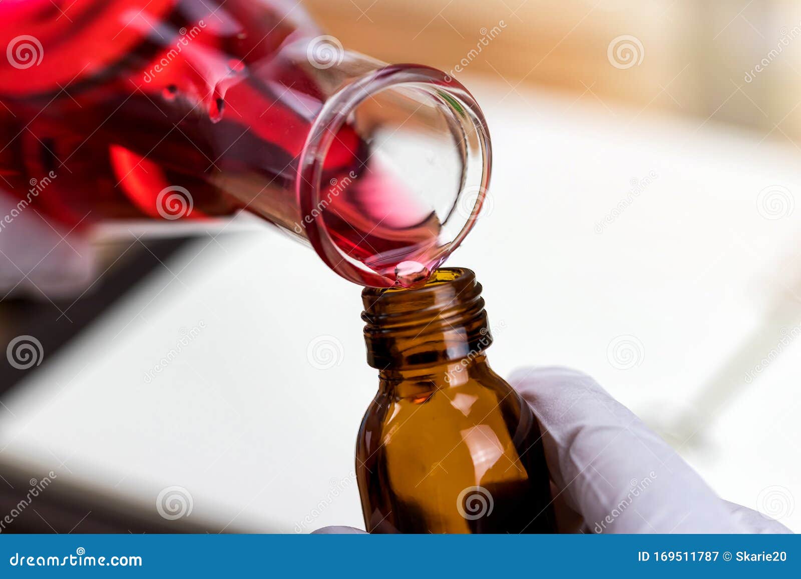 Researcher is Pouring Chemicals into Bottles. Scientist Working at the ... Researcher is Pouring Chemicals into Bottles. Scientist Working at the ...