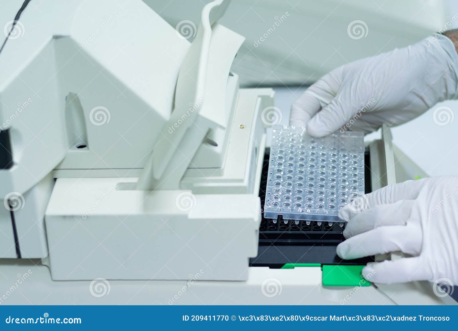 Researcher or Scientific Introducing a 96 Wells Plate in Quantitative ...