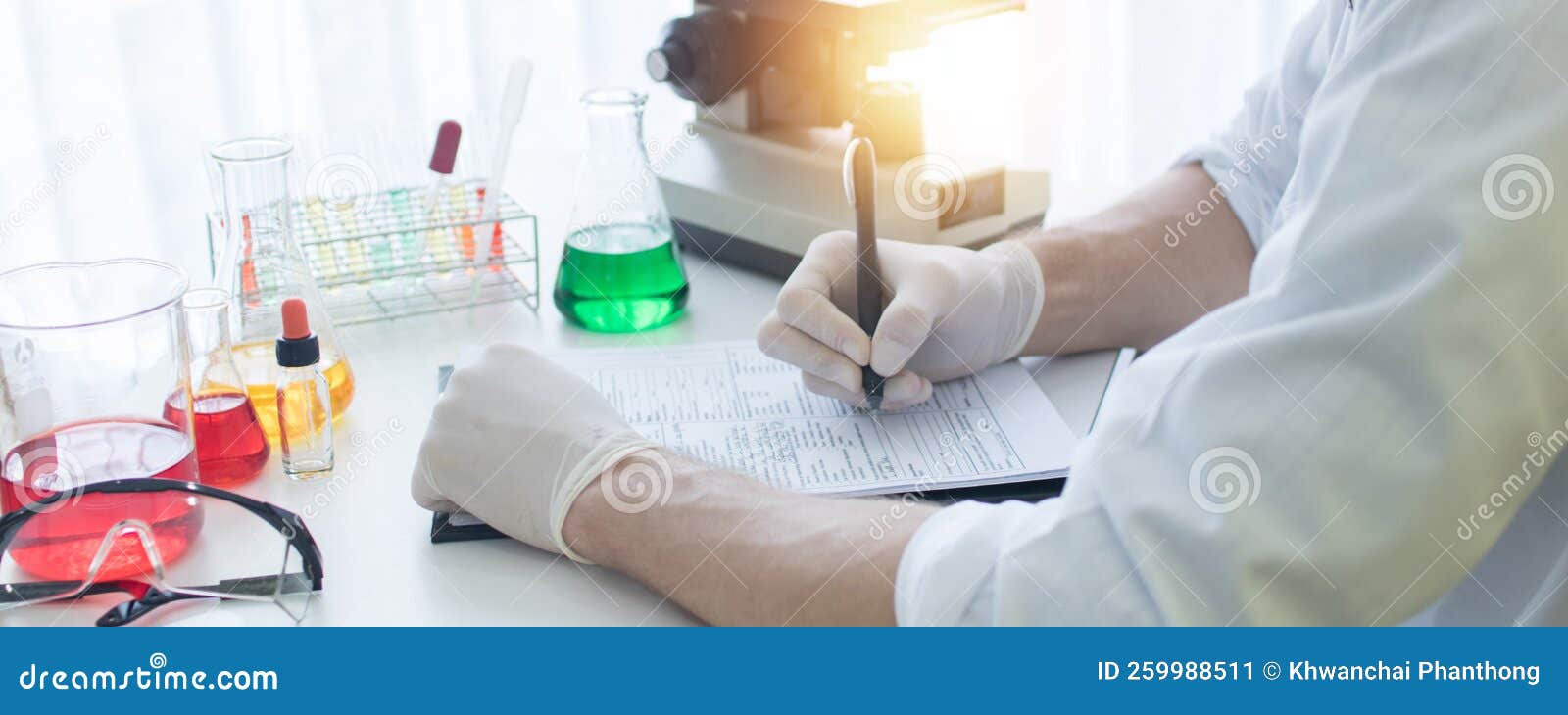 Researcher or Scientist Writing Information Result and Note on Paper in ...