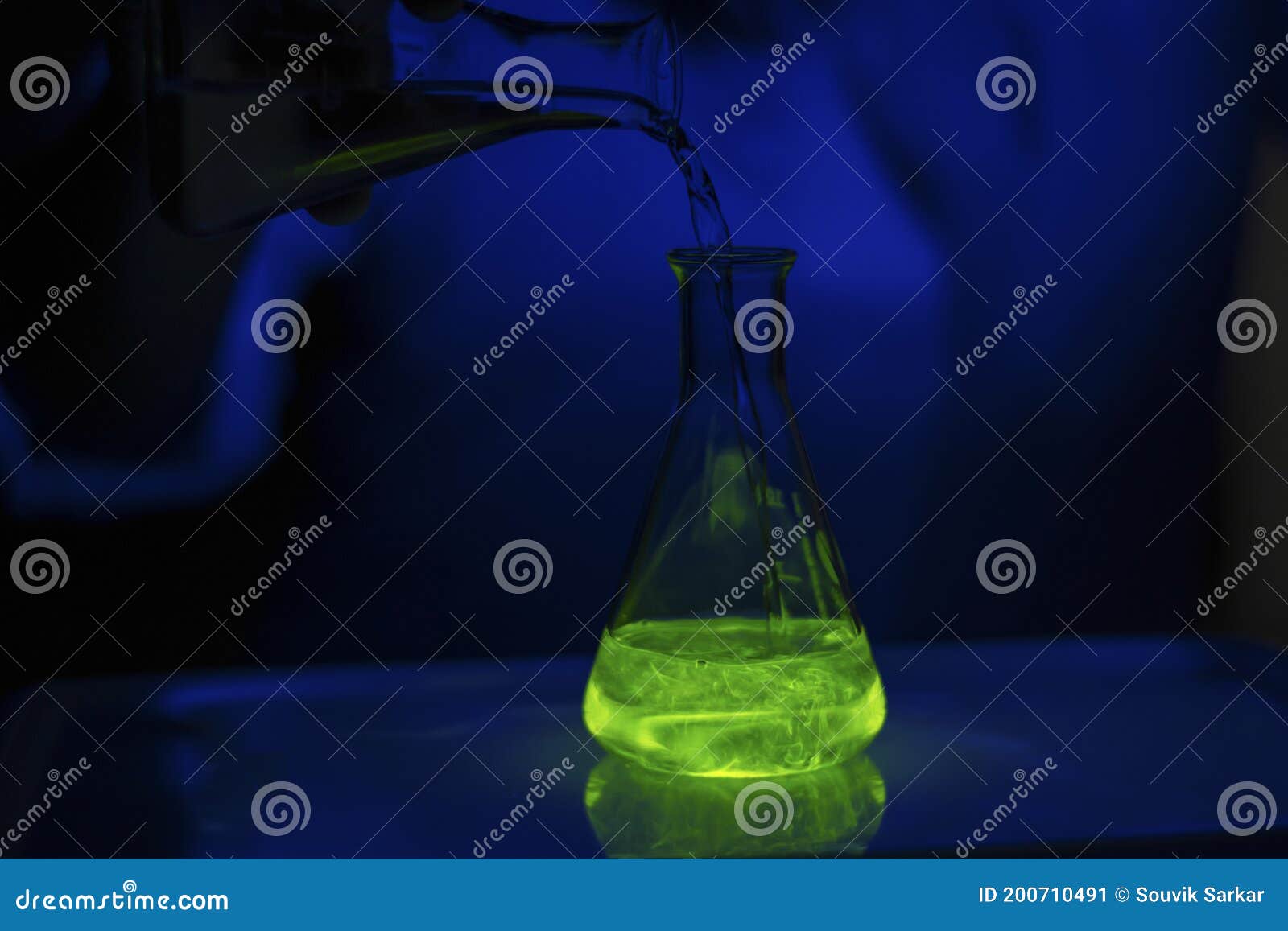 A Researcher Working with a Fluorescent Solution in a Glass Conical ...