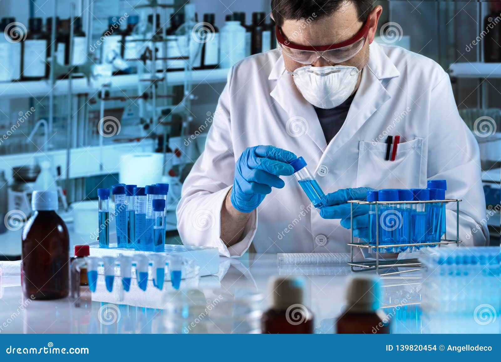 Researcher Working with Sample of Blue Fluid in Tube for Analysis in ...