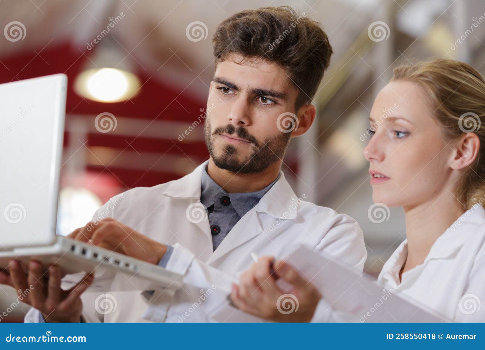Researchers In Labcoats Are Checking The Samples On Microscope I Stock ...