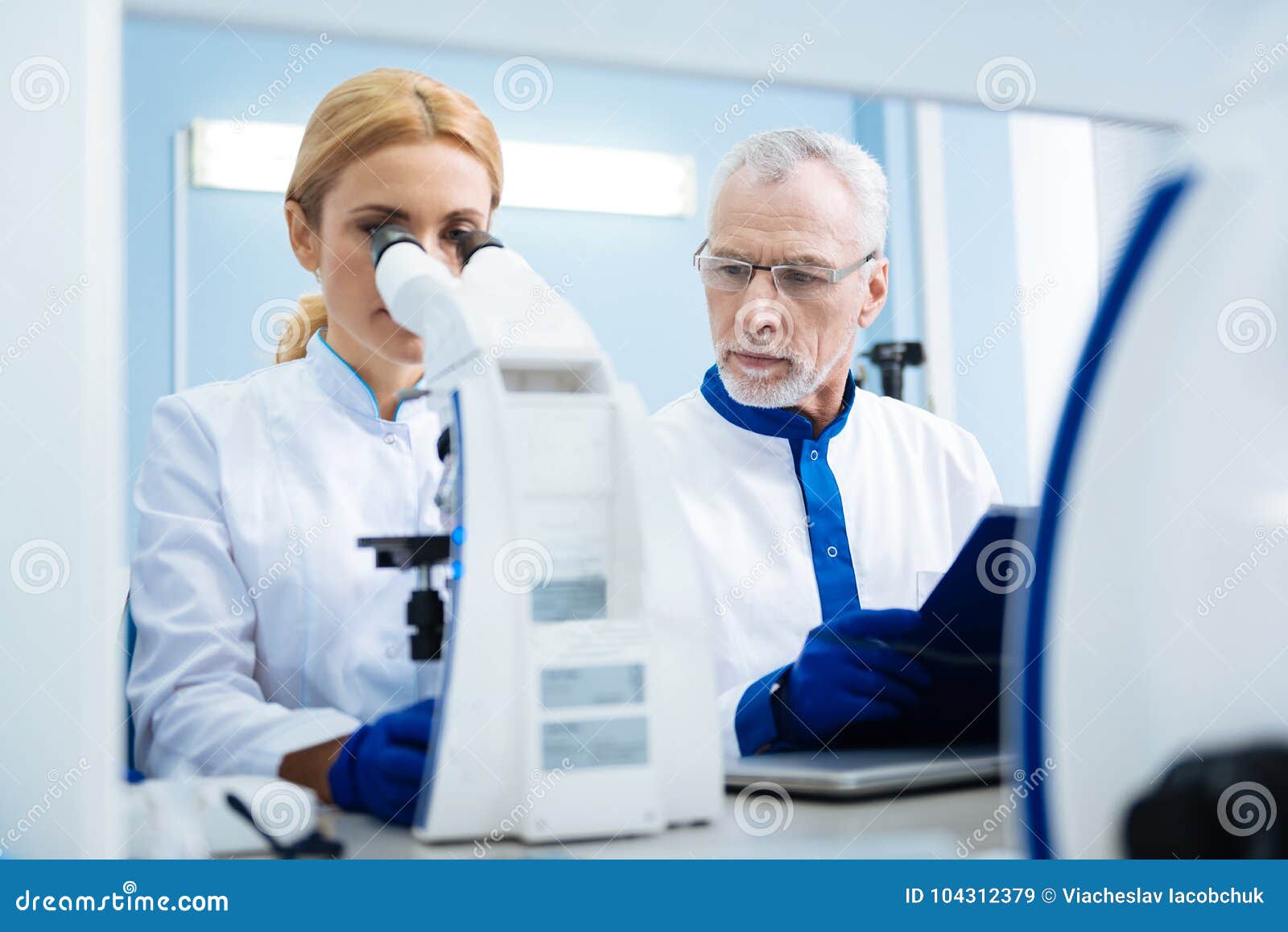 Researchers Working with a Microscope and a Tablet Stock Image - Image ...