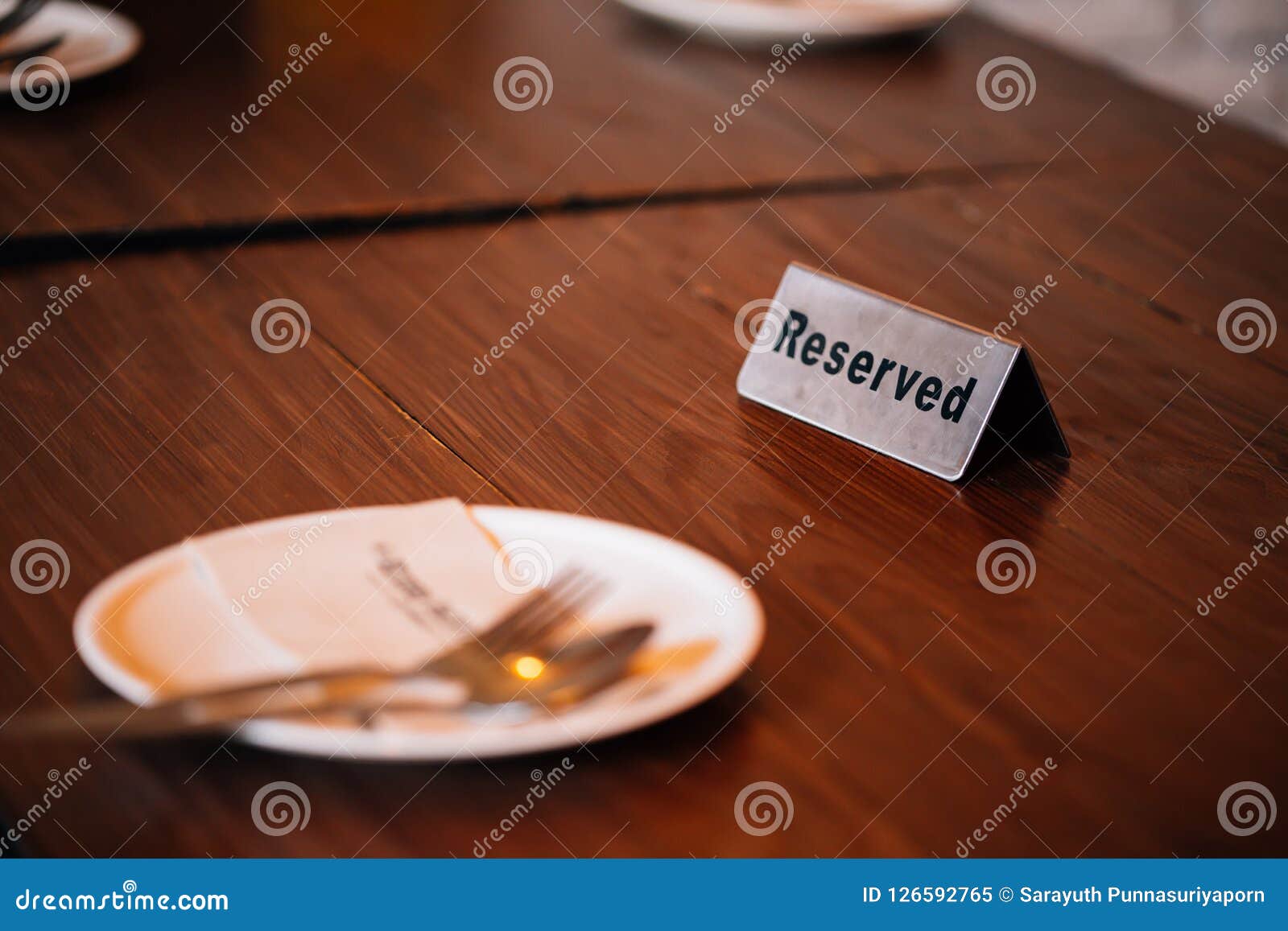 `Reserved` Sign on Dining Table in Restaurant with Spoon, Fork and ...