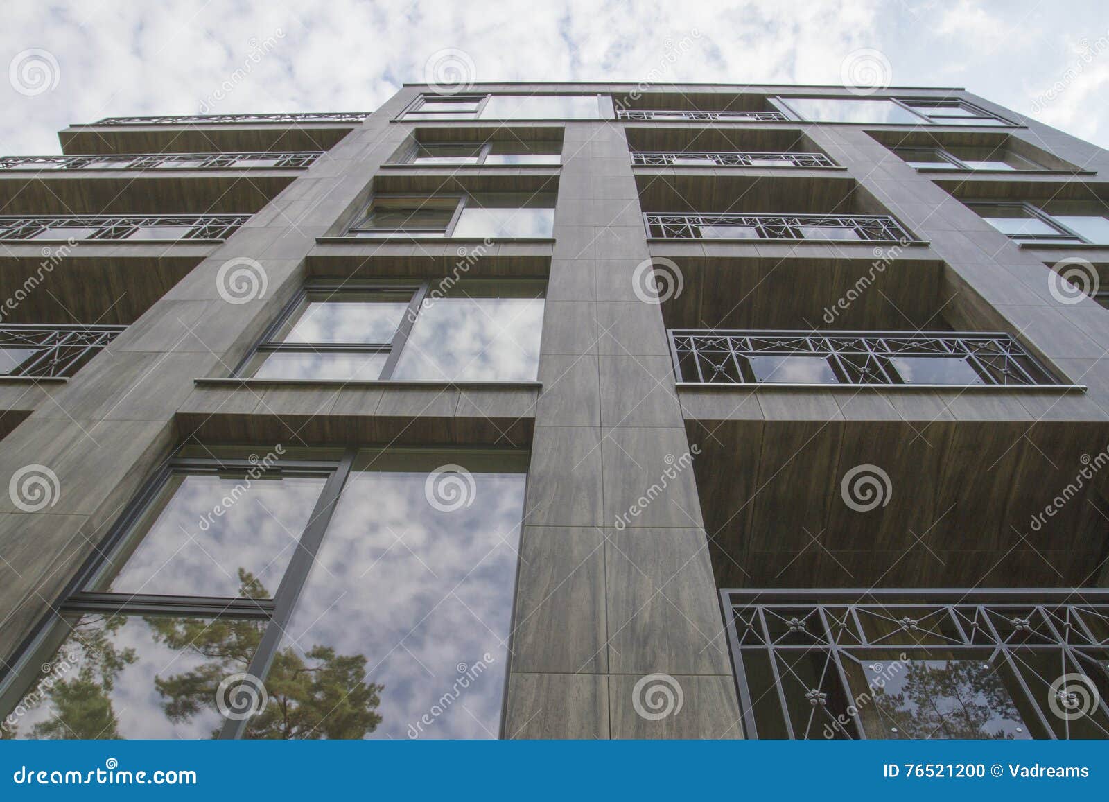 Residental Building on Sky Background and Trees Reflections in the ...