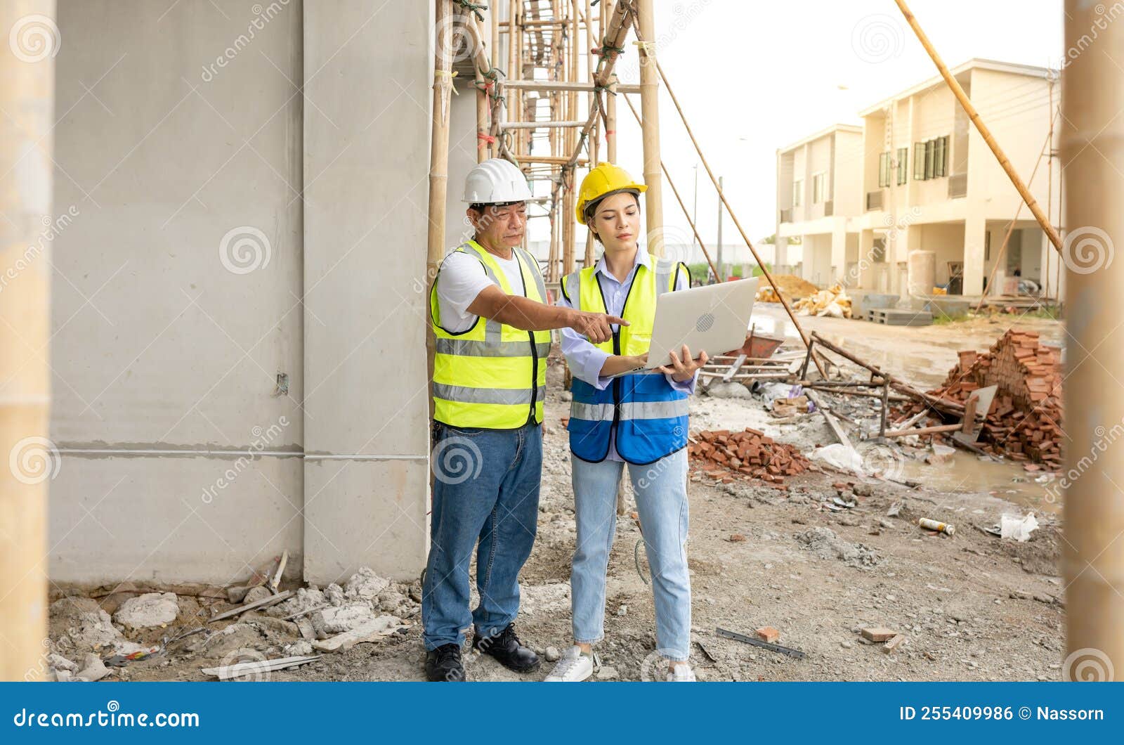 Residential Construction Workers Standing at Construction Site Talking on Housing Development ...