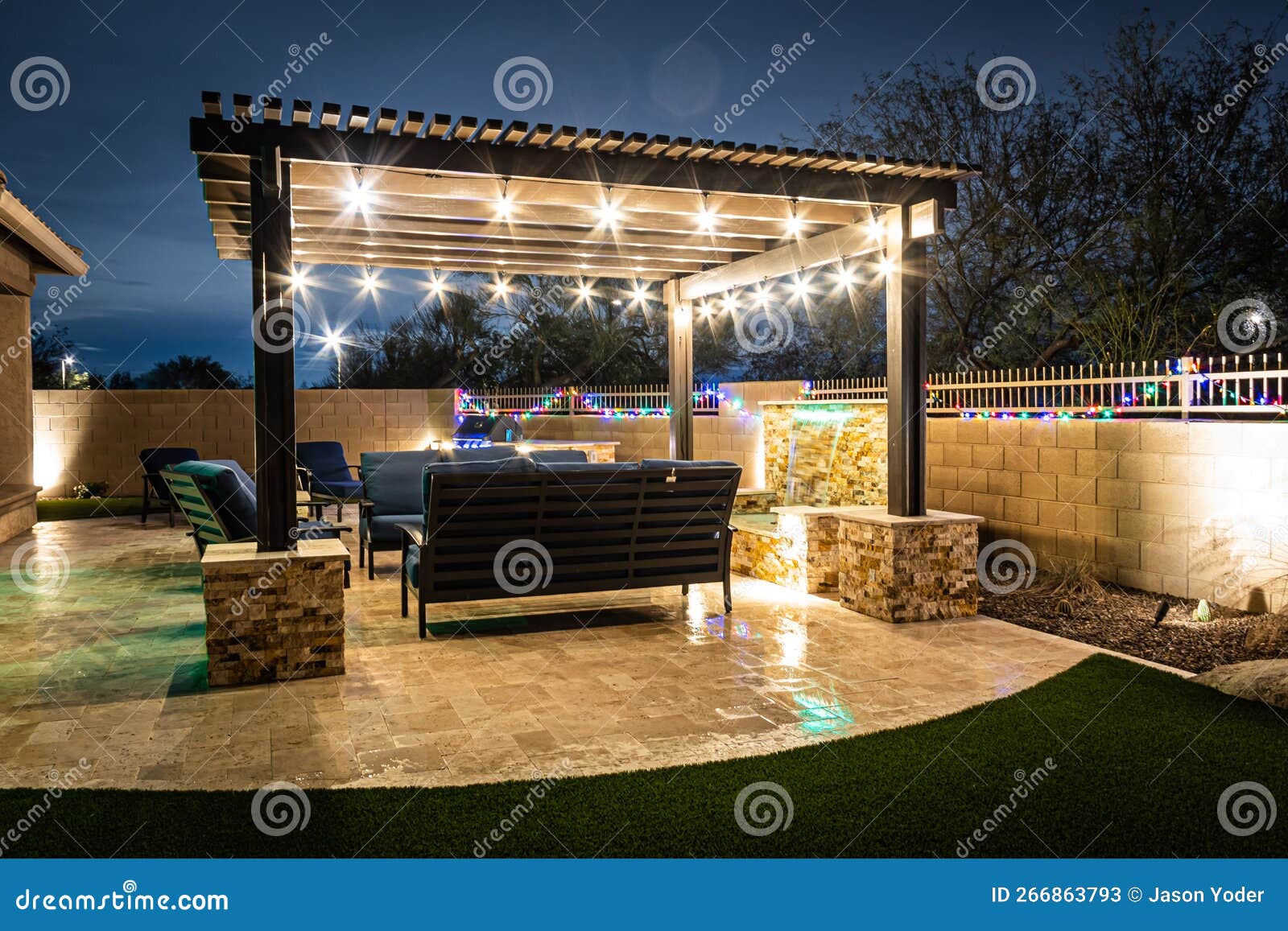 A Resort Style Backyard at Night with a Waterfall, Pergola, and a Firepit Stock Image - Image of ...