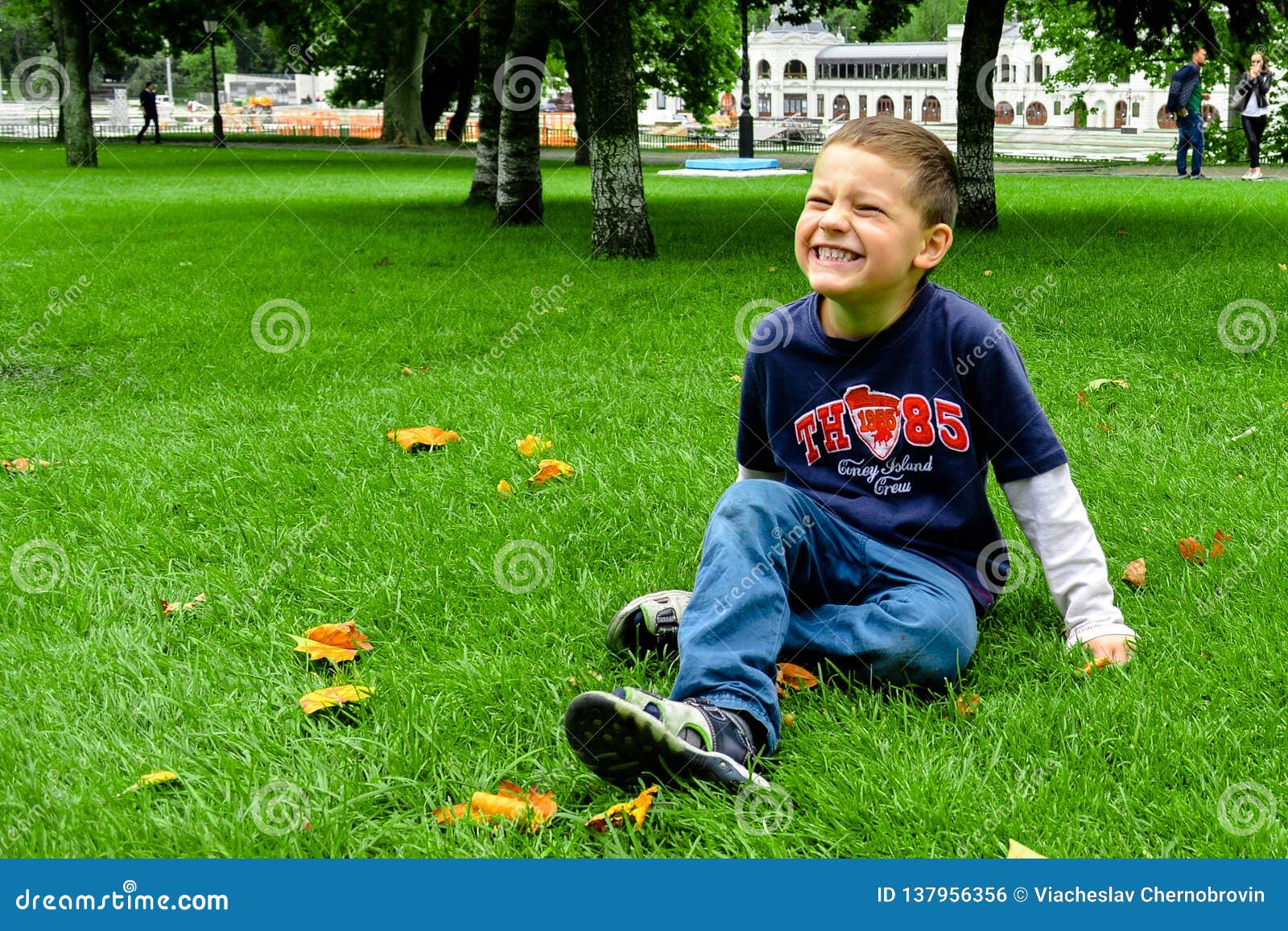 Smiling Boy Sitting on the Grass Stock Photo - Image of nature, grass ...