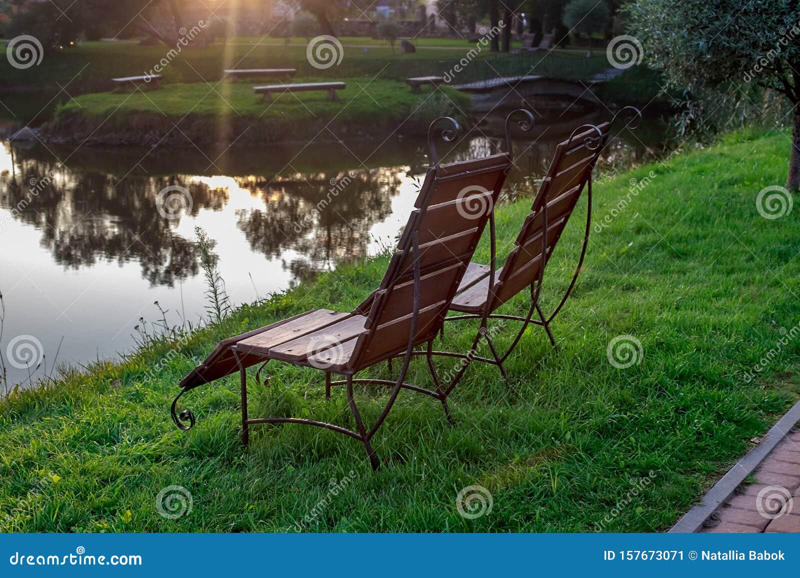 Rest Zone. Wooden Chairs Stand on the Grass by the Lake, Facing the ...