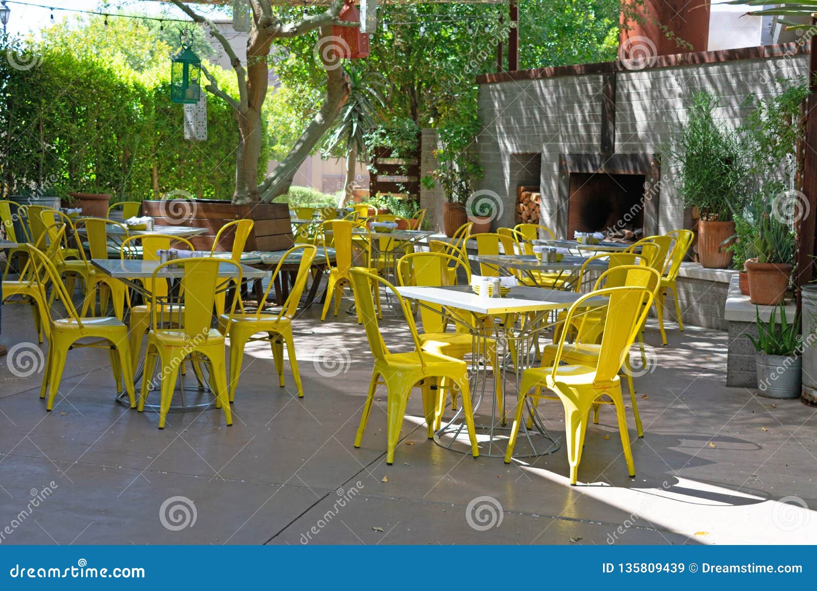 Restaurant Courtyard with Yellow Chairs Under the Trees Stock Image ...