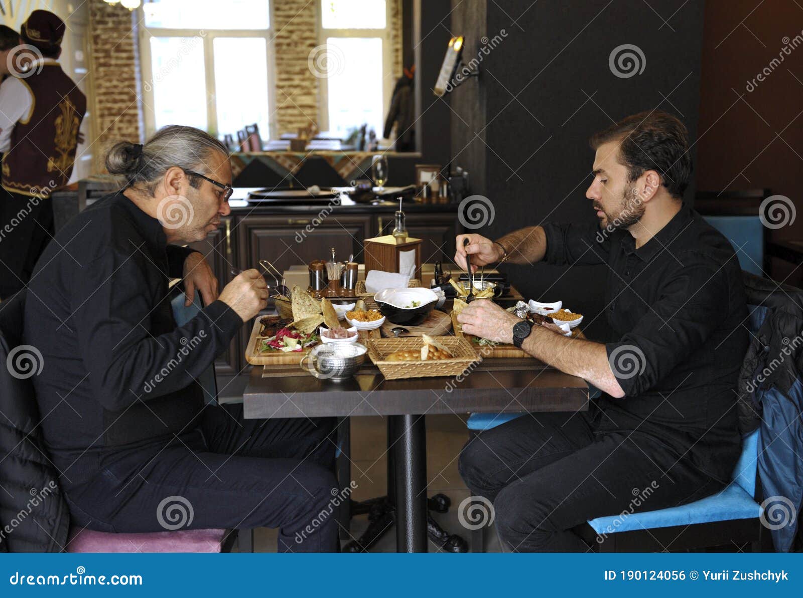 Restaurant Customers Sitting at the Table and Having Dinner in a ...