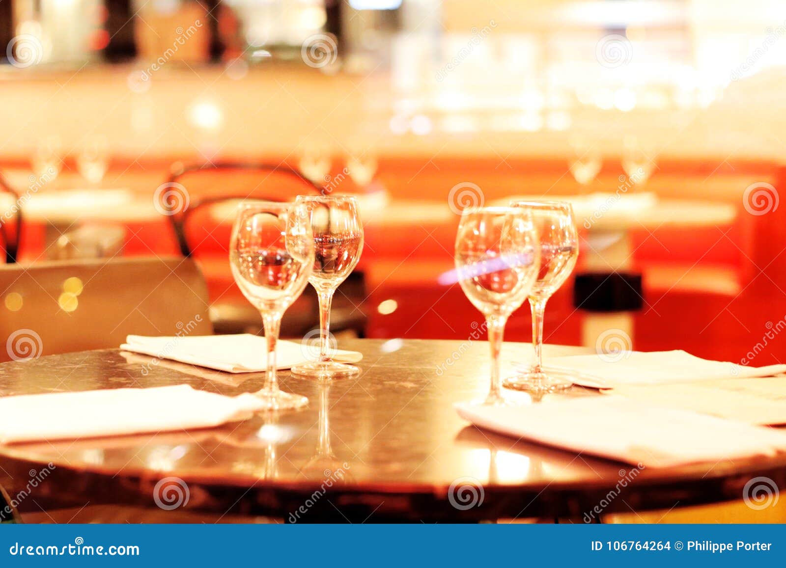 Empty Restaurant Background with Wineglasses and Napkins in Front of ...