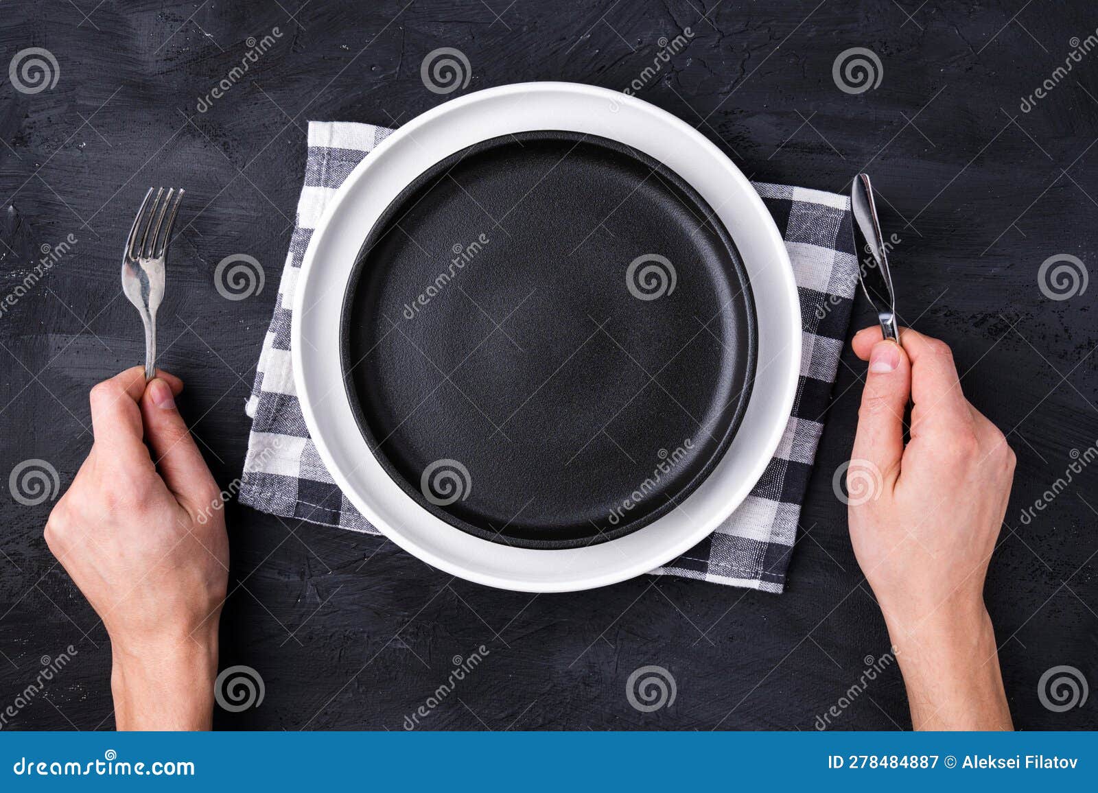 Man with a Fork, a Knife and an Empty Plate on a Black Background, Top ...