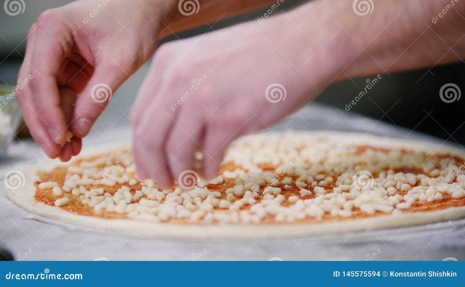 Restaurant Kitchen. a Chef Putting Cheese on the Pizza Stock Photo ...
