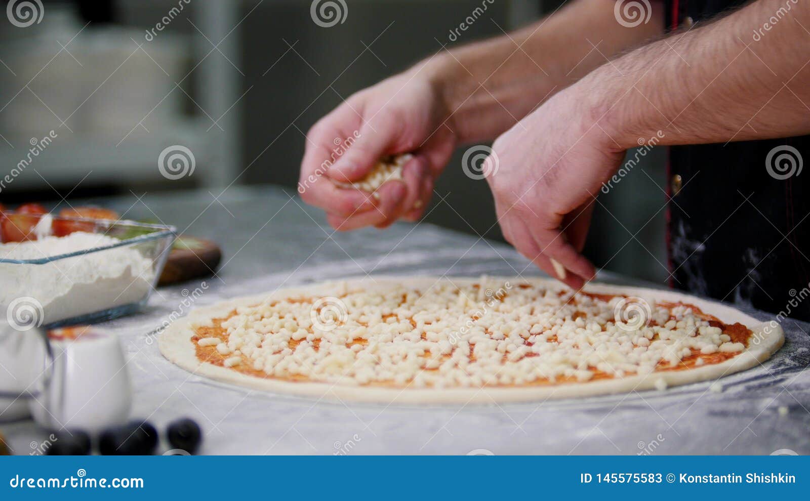 Restaurant Kitchen. a Chef Putting Cheese on the Pizza Stock Image ...
