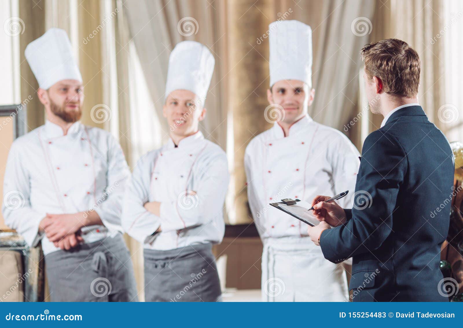 Restaurant Manager and His Staff in Kitchen. Interacting To Head Chef ...