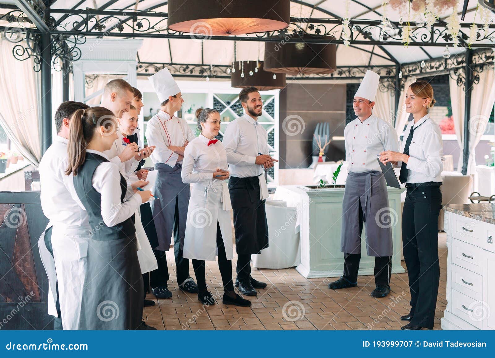 Restaurant Manager and His Staff in Terrace. Interacting To Head Chef ...