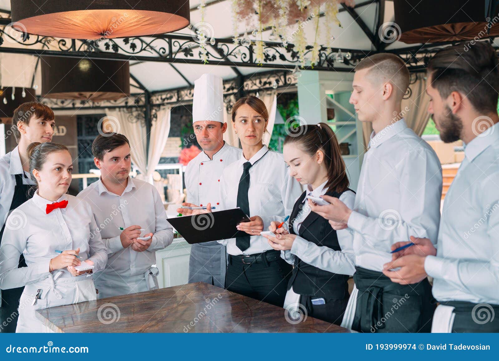 Restaurant Manager and His Staff in Terrace. Interacting To Head Chef ...