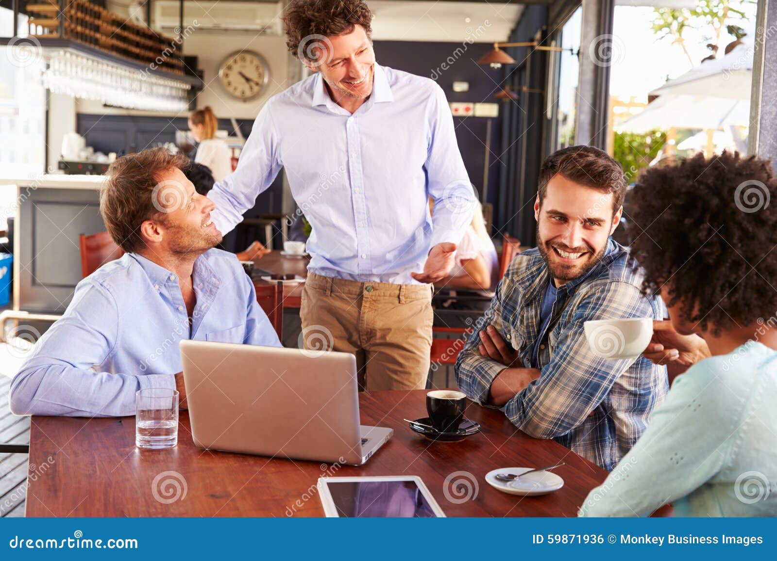 Restaurant Manager Talking To Customers at Their Table Stock Photo ...