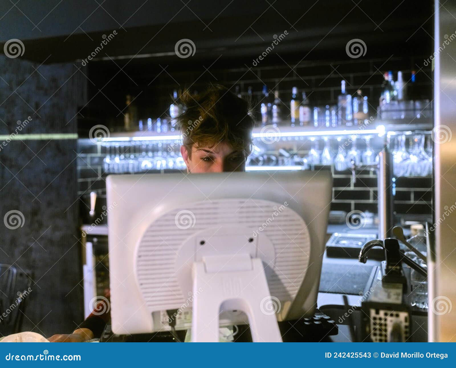 Restaurant Manager Working at the Reception Desk Using a Computer Stock ...