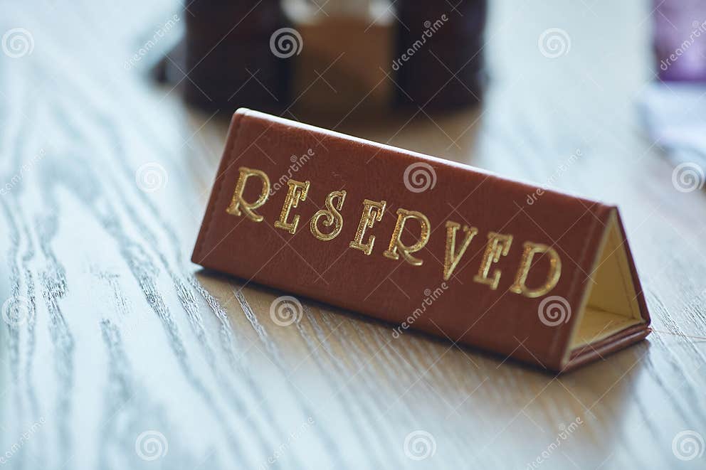 Restaurant Reserved Table Sign. a Brown Reserved Sign is on the Table ...