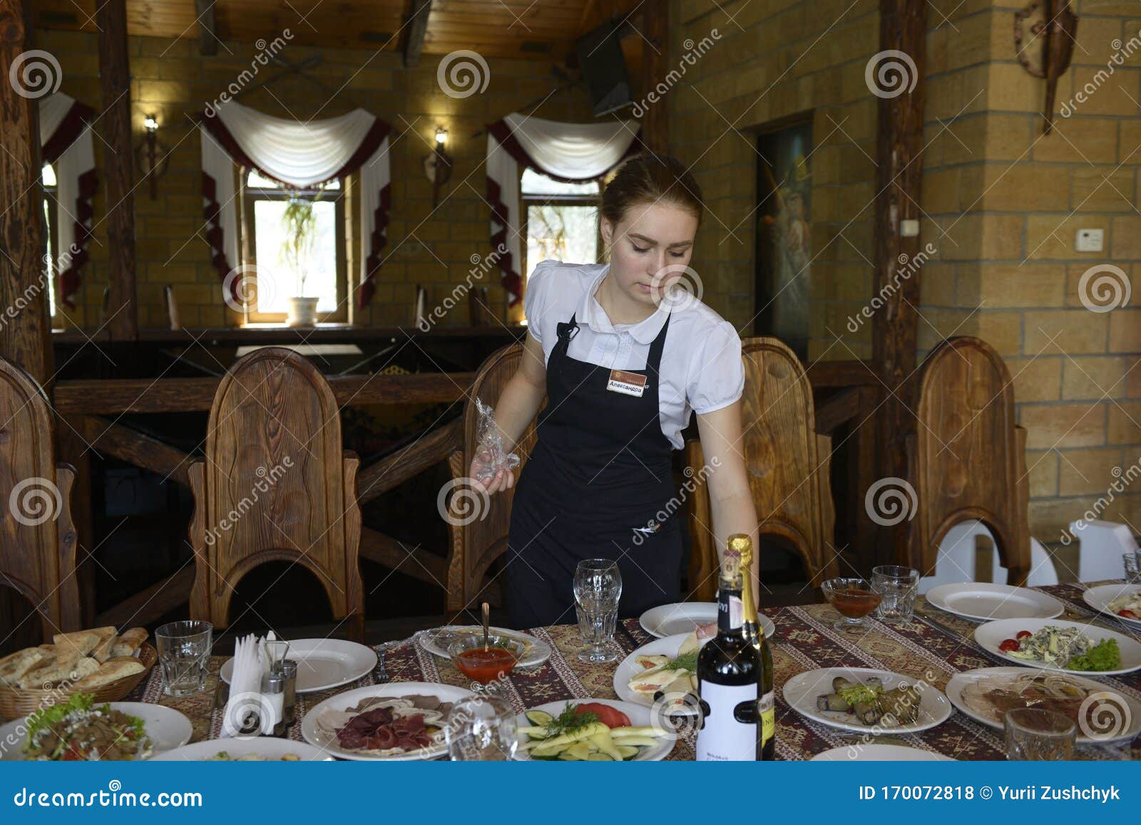 At A Restaurant: Waitress In Uniform Setting The Table Editorial Photo ...