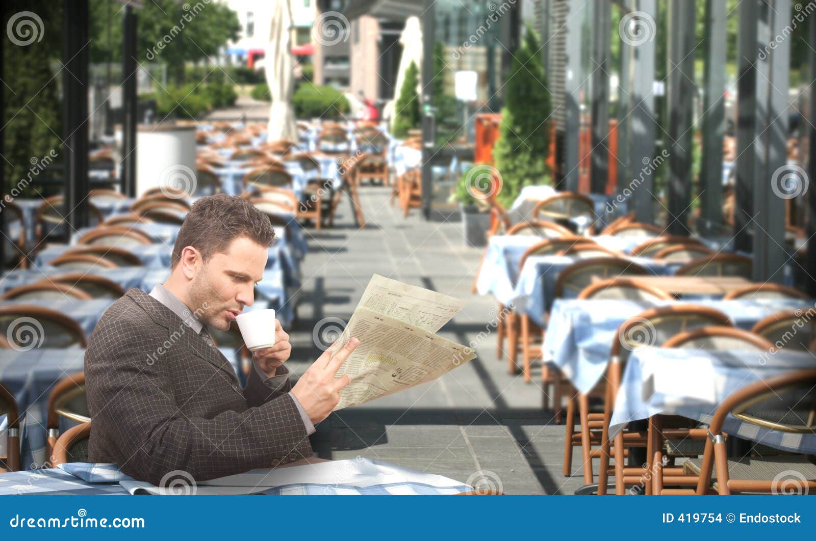 Resting Businessman Drinking Coffee and Reading Newspaper in the ...