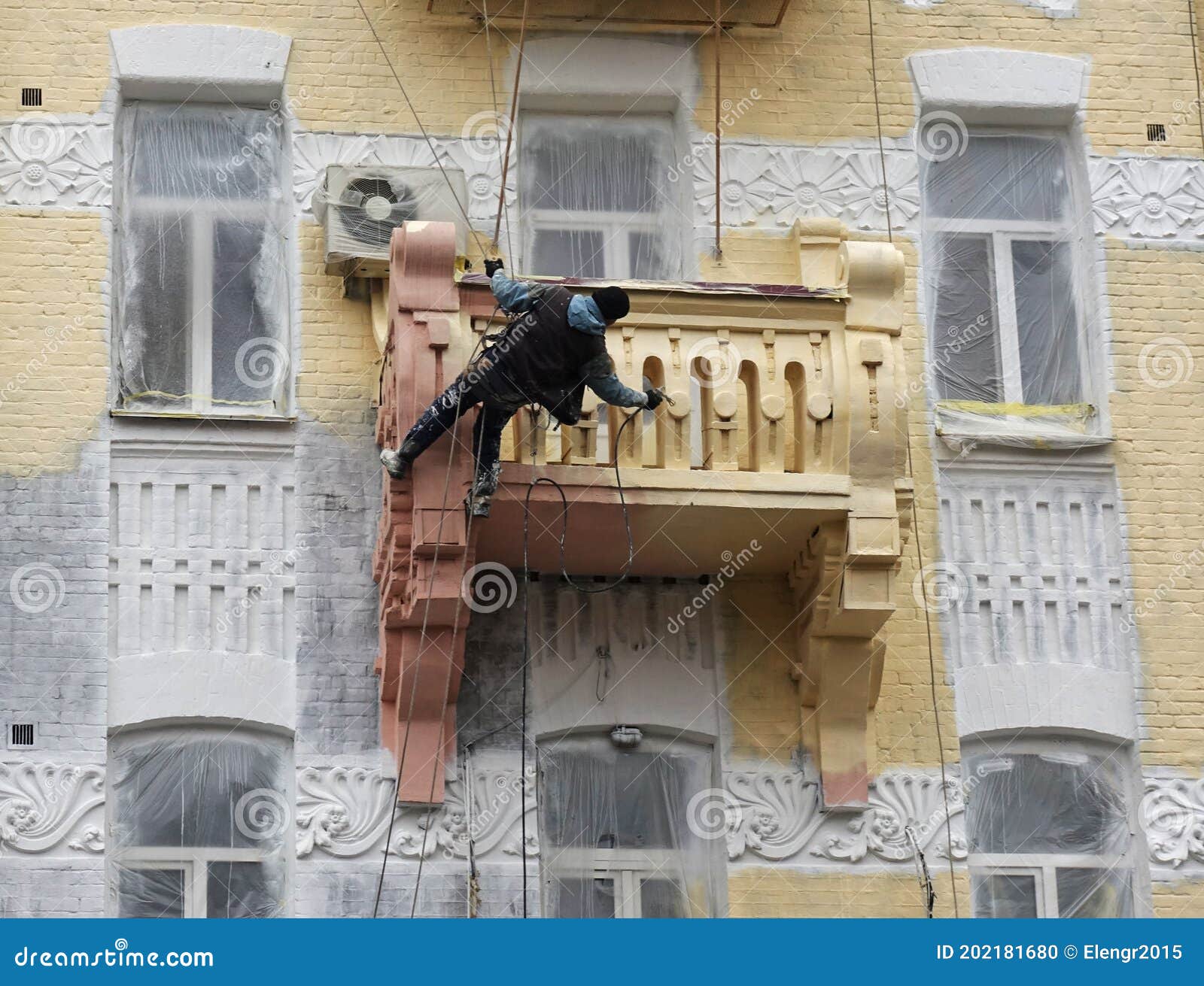 Restoration Work in the Old Building. High-rise Painter Paints the ...