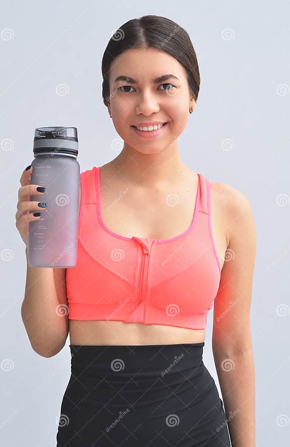 Restoring Water Balance Portrait Of Young Woman In Sports Wear Keeping