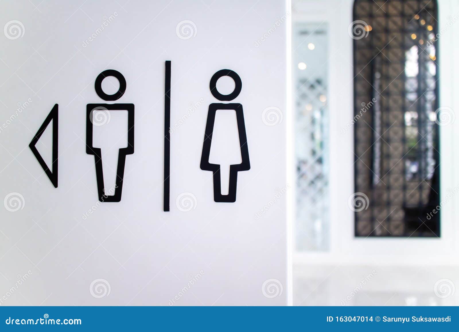 Restroom Toilet Sign on the Wall Shows Direction on the Left Side Stock ...