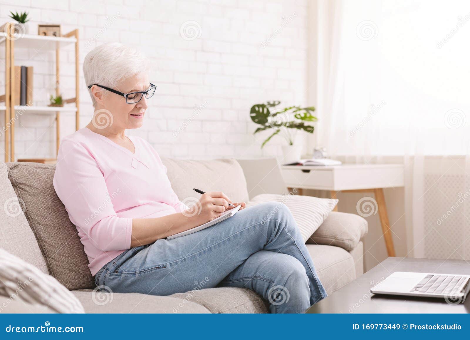 Retired Lady Writing Notes Using Laptop at Home Stock Image - Image of ...