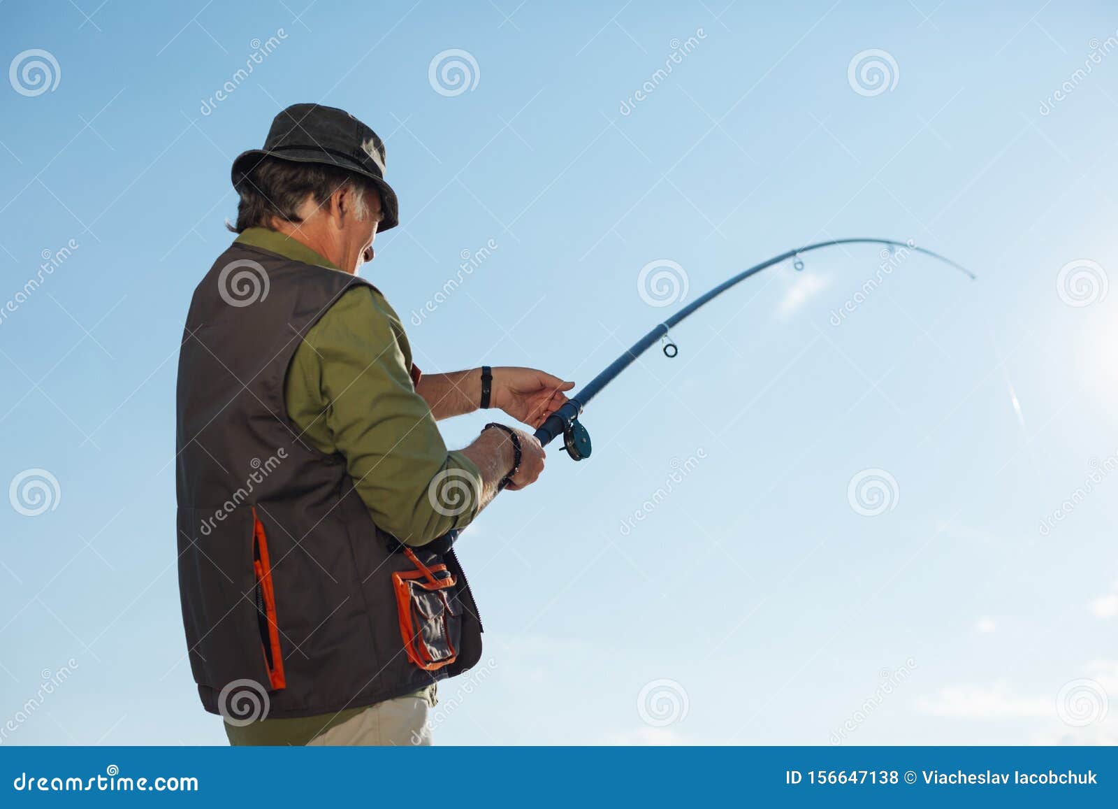 Retired Man Pulling Fishing Tackle after Catching Fish Stock Photo ...