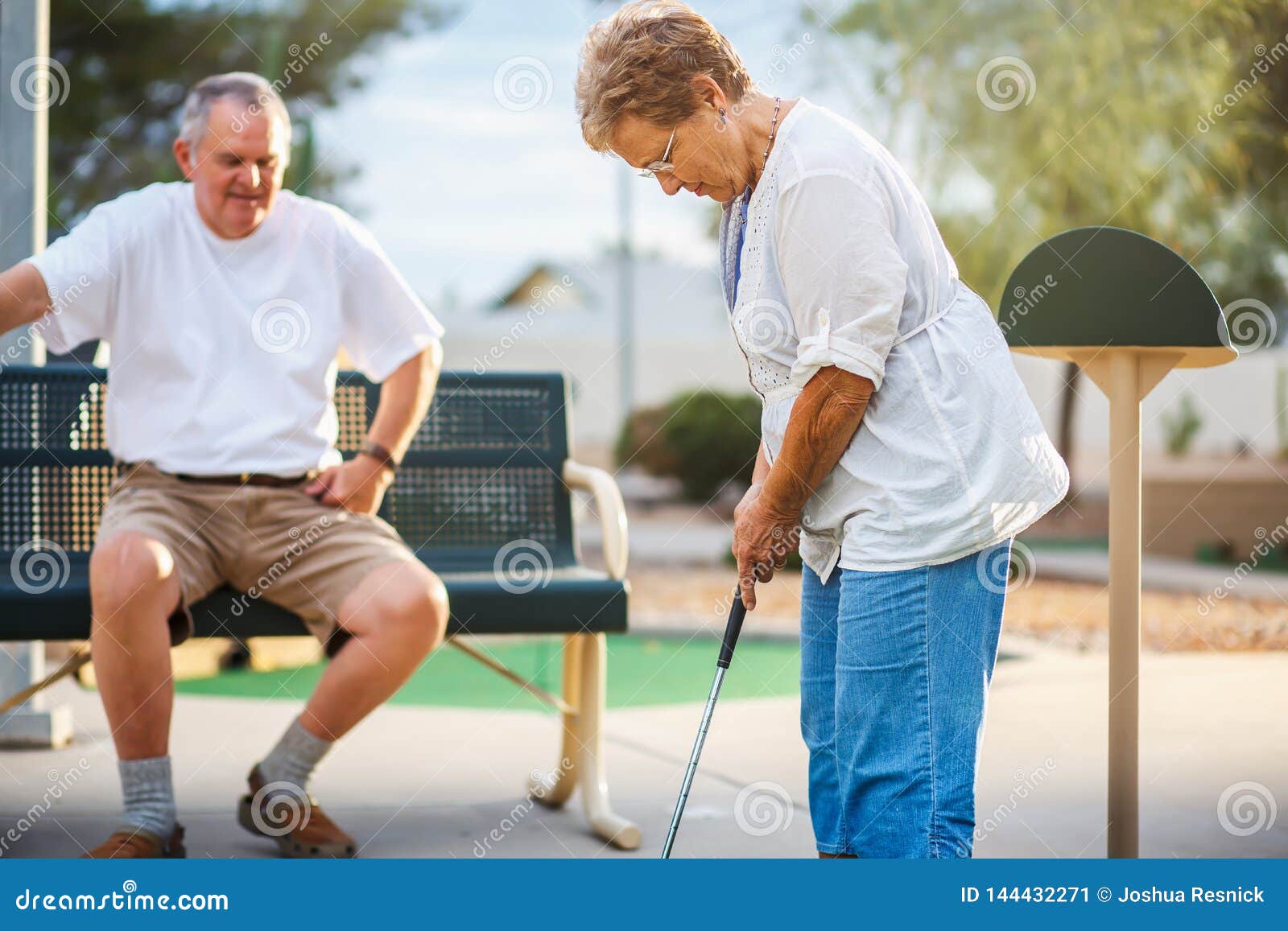 Retired Senior Couple Playing Mini Golf Together Stock Image - Image of ...