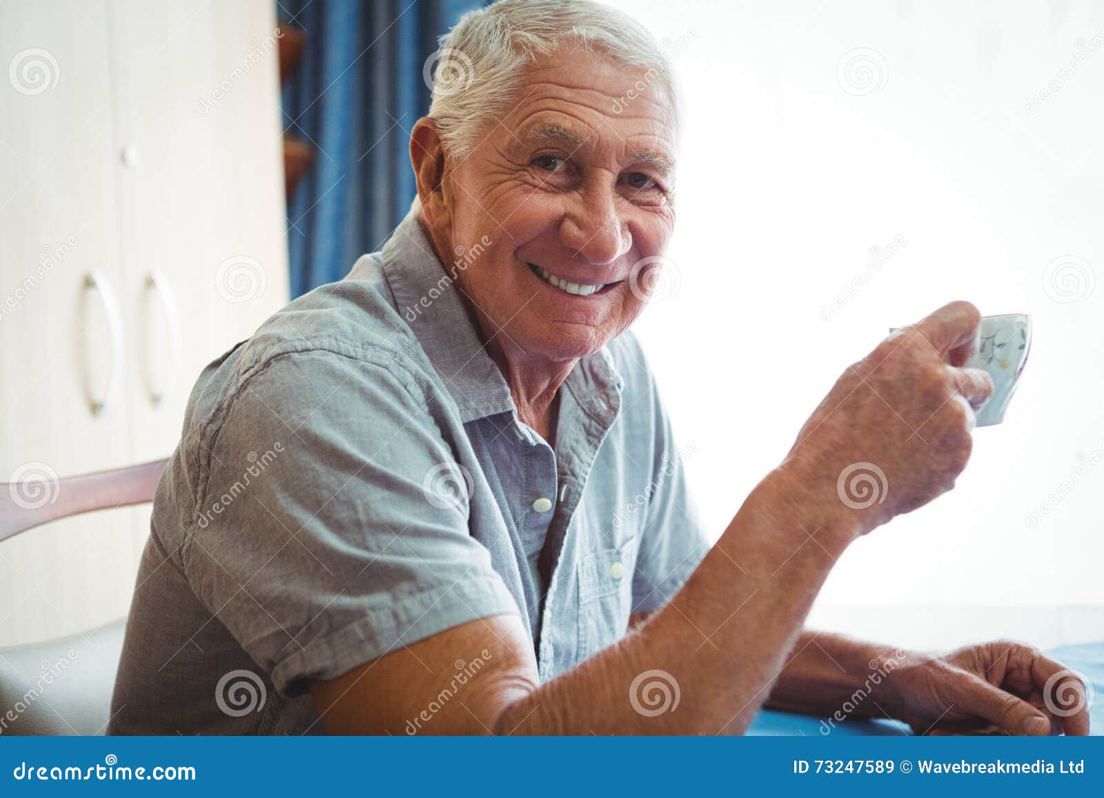 Retired Smiling Man Holding a Cup of Tea Stock Image - Image of ...