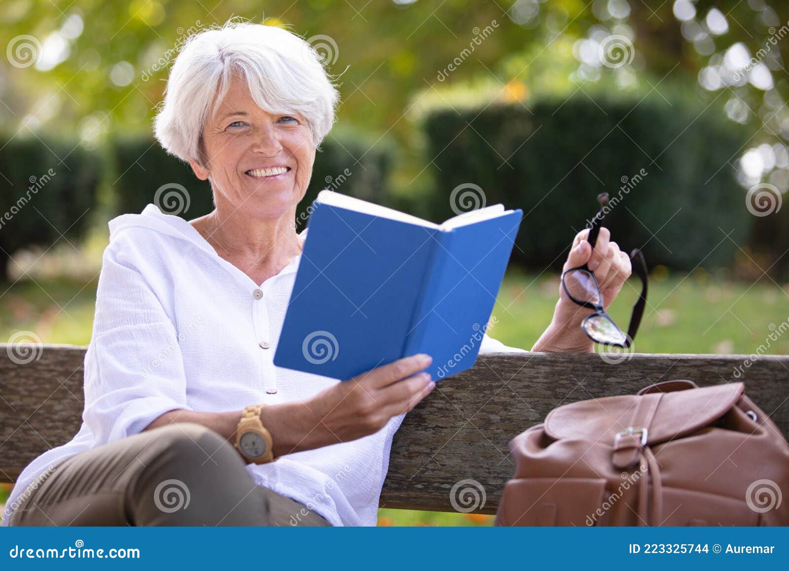Retired Woman Reading Book on Bench Stock Photo - Image of caucasian ...