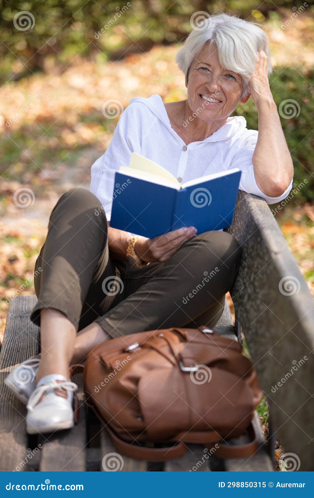 Retired Woman Reading Book on Bench Stock Image - Image of back ...