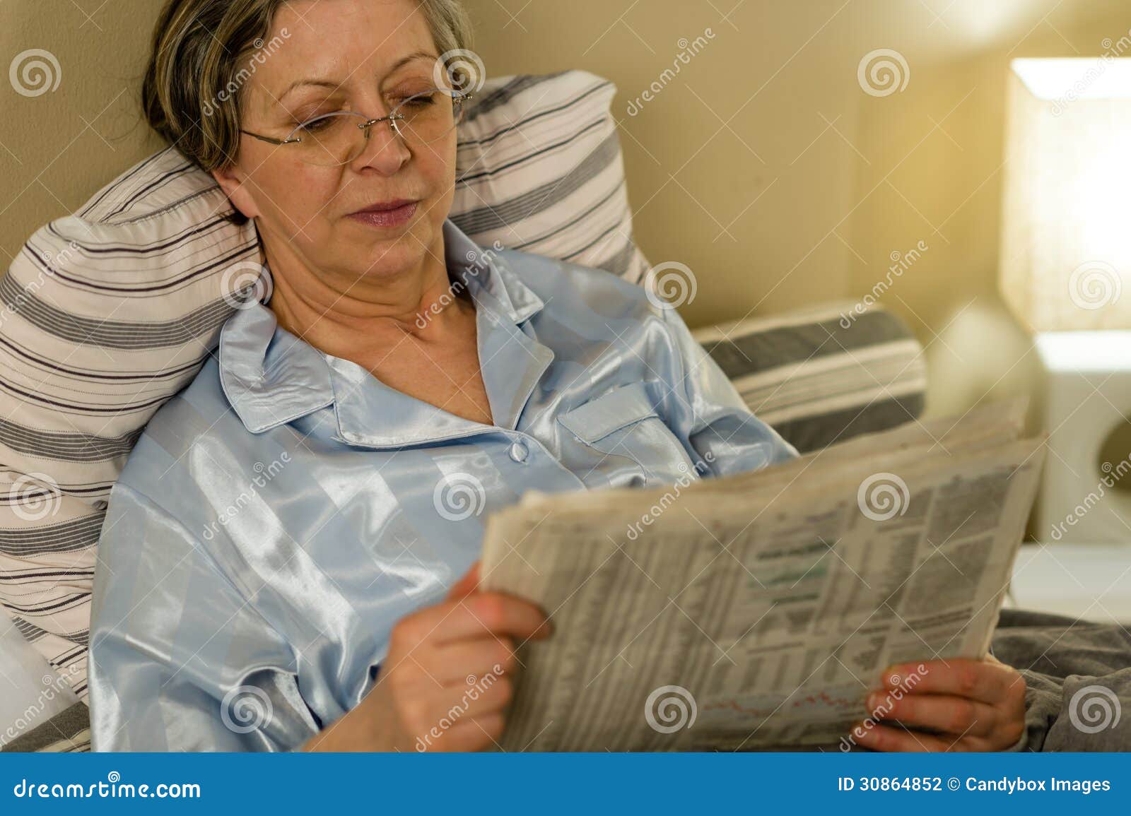 Retired Woman Reading Newspaper before Sleeping Stock Photo - Image of ...