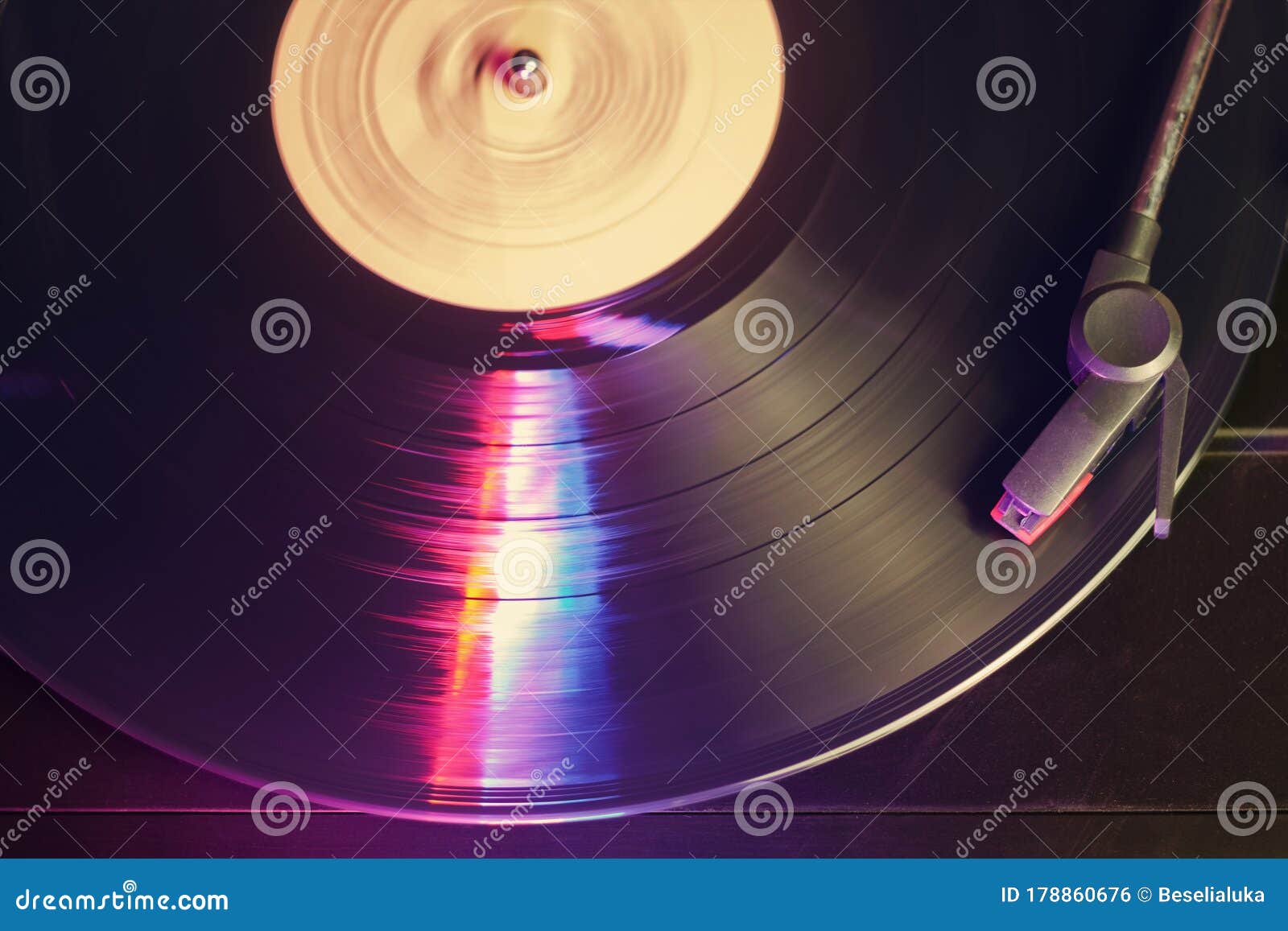 Record Player with a Spinning Black Vinyl Record Reflecting Color ...