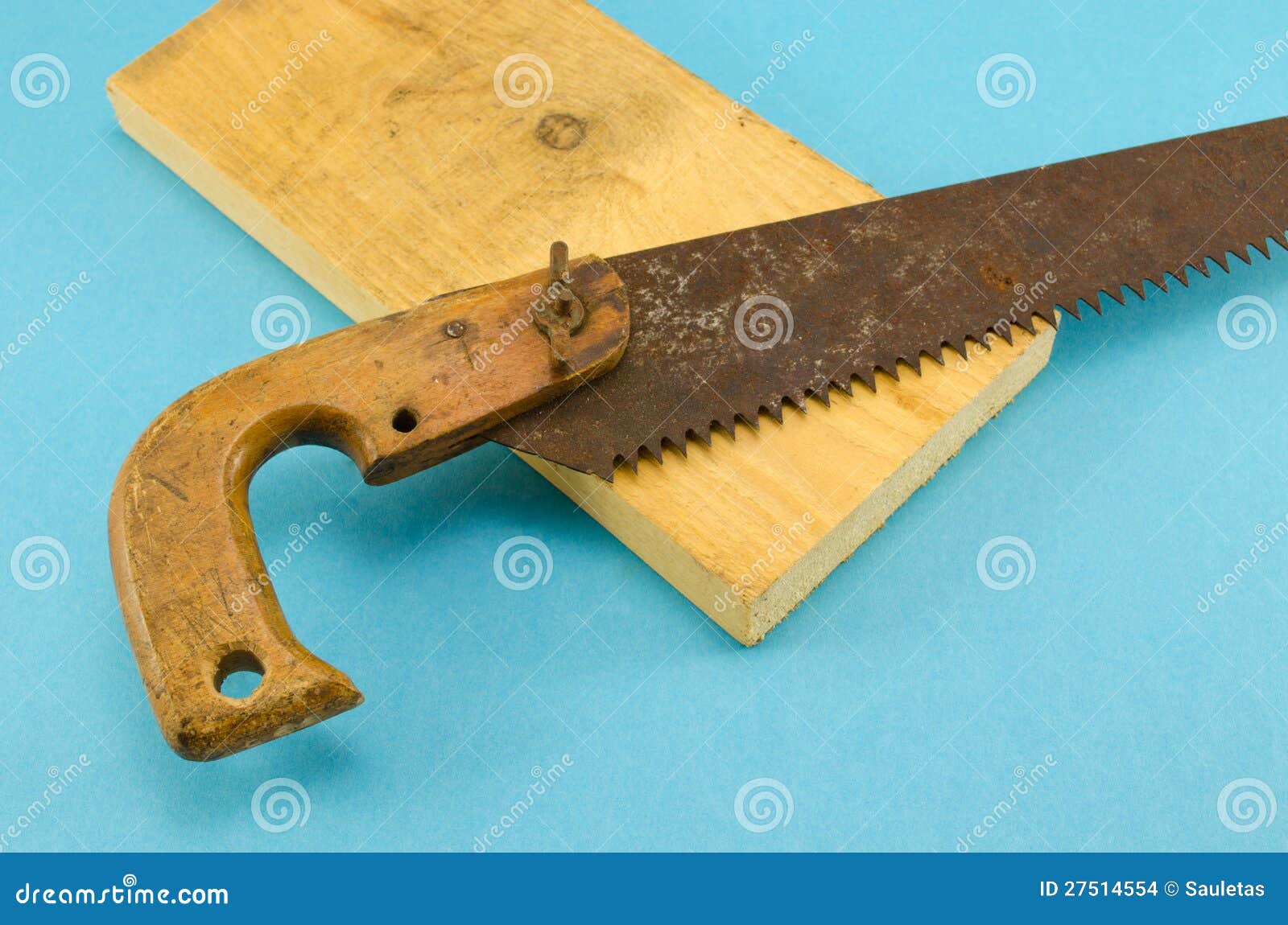 Retro Rusty Hand Saw and Wood Board Part on Blue Stock Photo - Image of ...