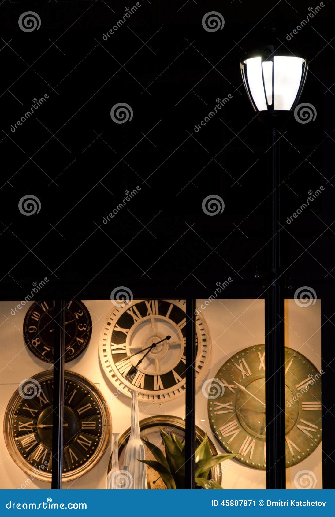 Retro Wall Clock in a Window of Shop Closed for Night Stock Image ...