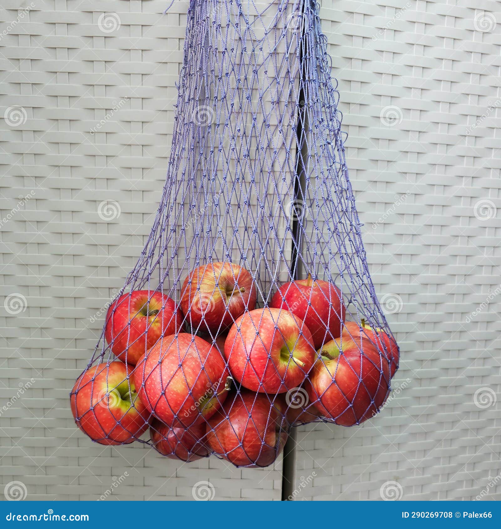 Reusable Thread Mesh Filled with Red Apples Hanging on the Pantry Door ...